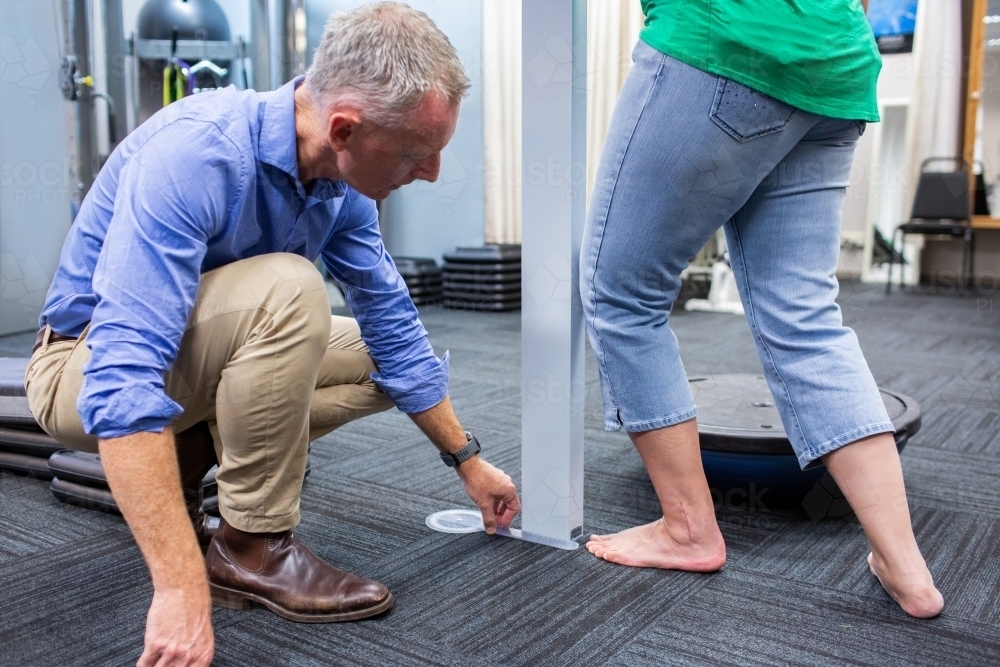 Image of Physio measuring flexibility after leg injury - Austockphoto