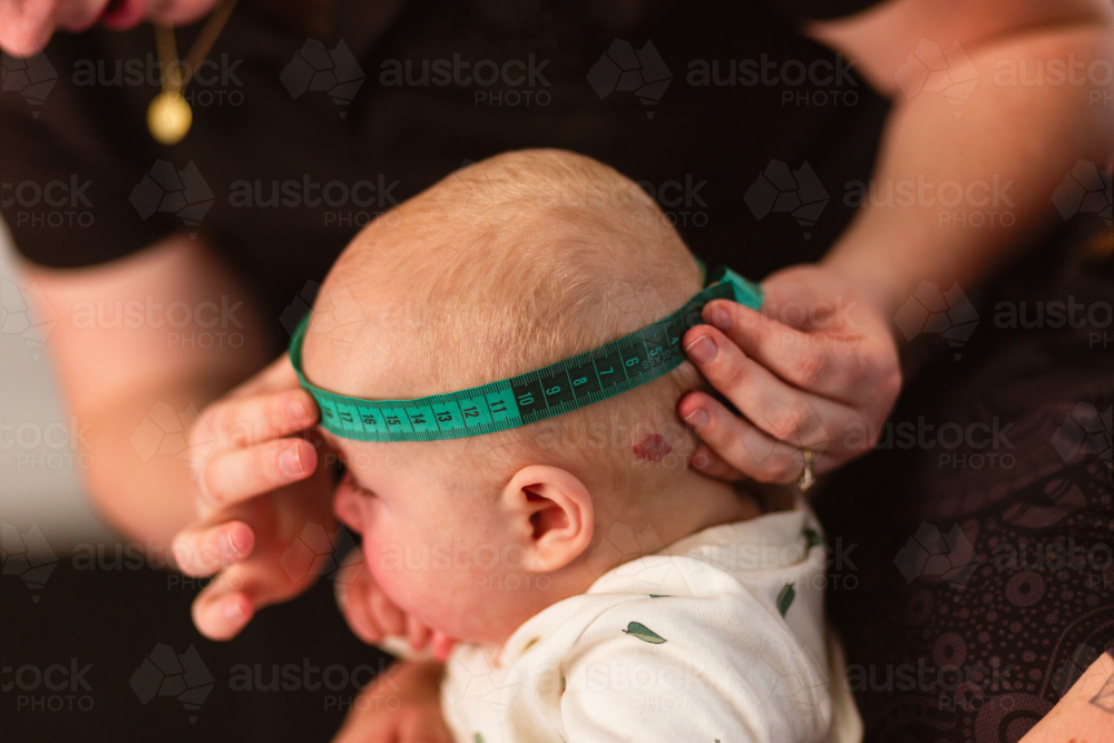 Image of Physio performing Cranial Measurement assessment on baby ...