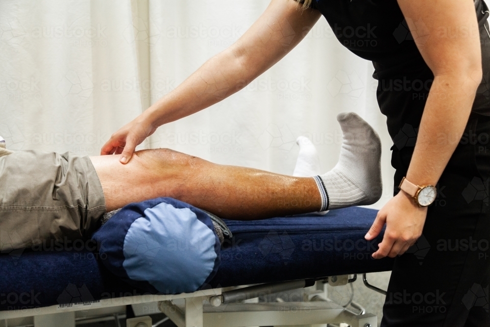 Image of Physio practitioner working with client with knee injury ...