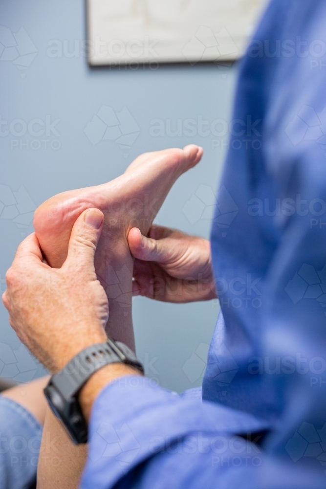 Image of Physio working on clients foot in therapy clinic helping heal ...