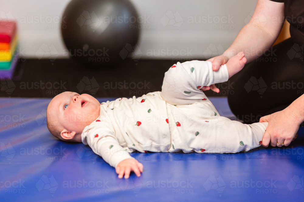 Image of physiotherapist woman working with baby on therapy mat ...