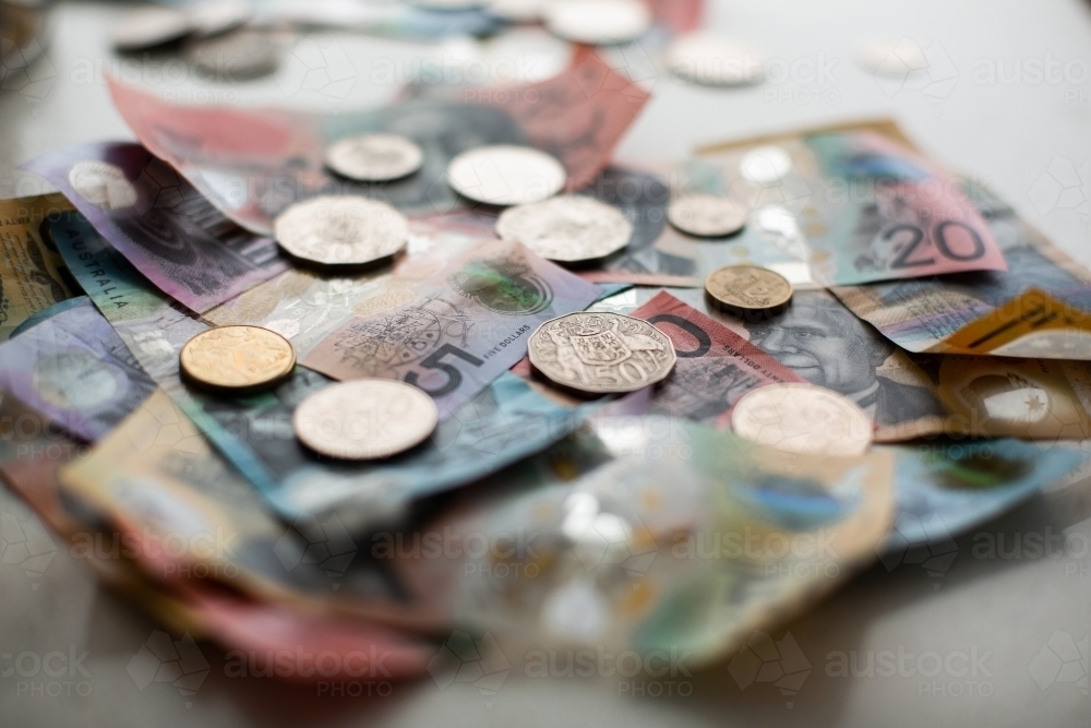 Image of pile of money australian currency on a kitchen bench ...