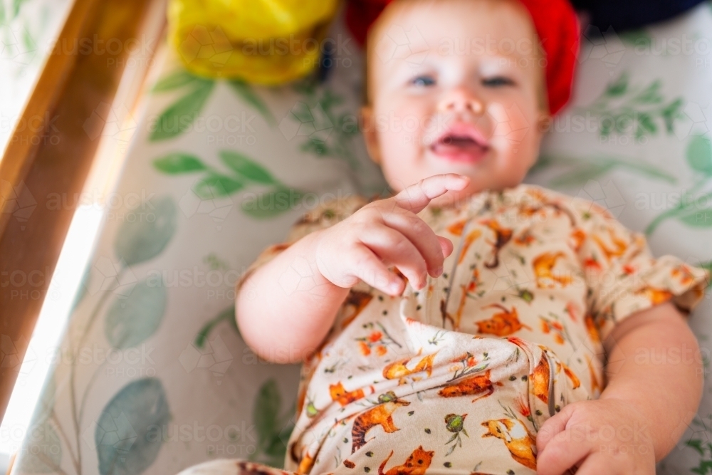 Image of Pointing finger of baby lying on change table ready to get ...