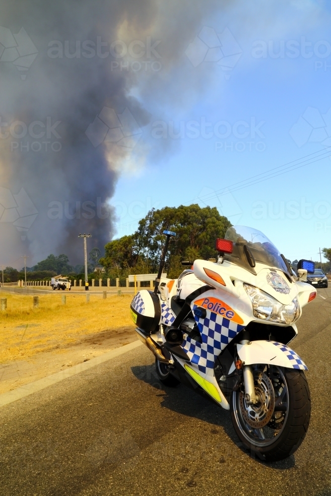 Image of Police motorcycle roadblock due to bushfire. - Austockphoto