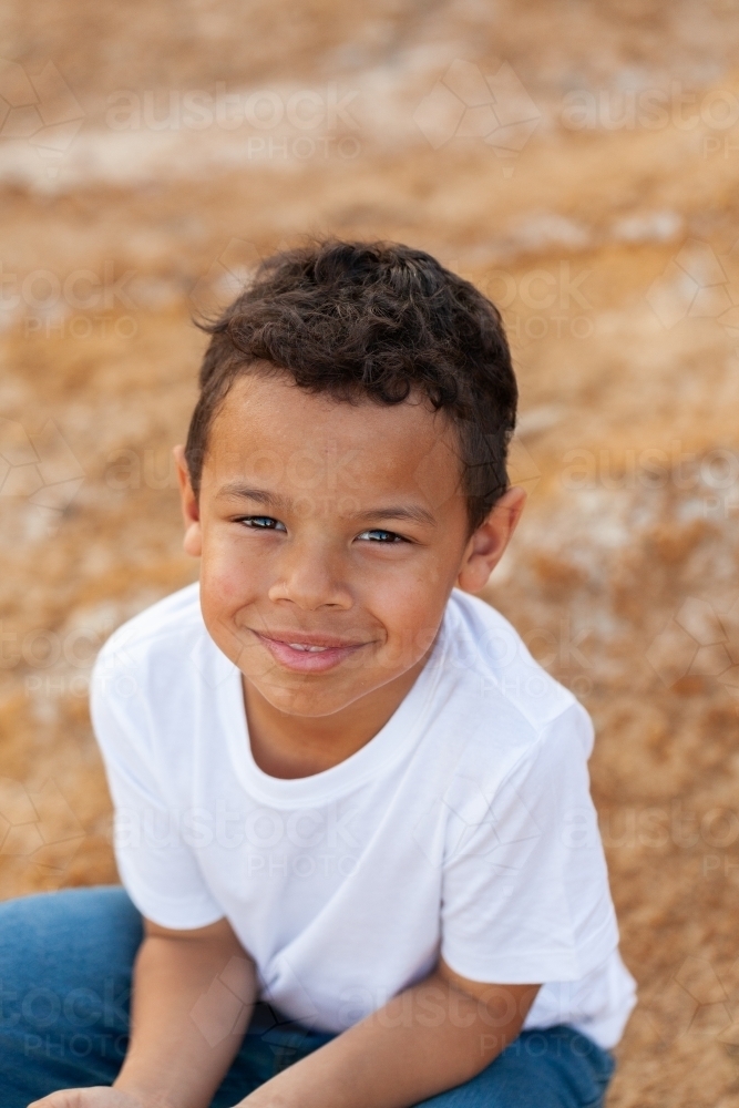 Image of Portrait of a first nations Australian boy looking up at ...