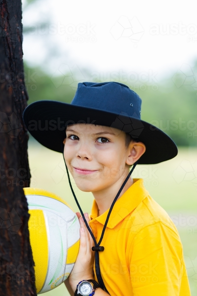 Image of Portrait of a happy aussie school boy outside with a hat on ...