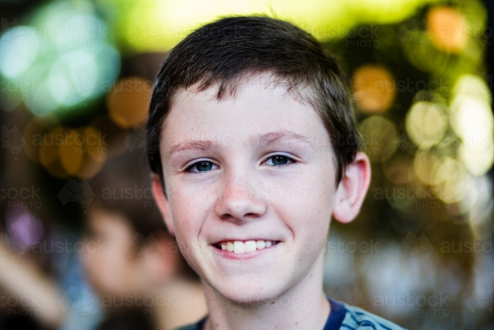 Image of Portrait of a happy eleven year old boy with blurred ...