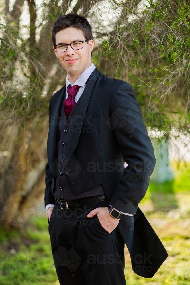 Image of Portrait of a happy young man dressed up in a fancy suit ...