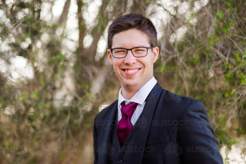 Image of Portrait of a happy young man dressed up in a fancy suit ...