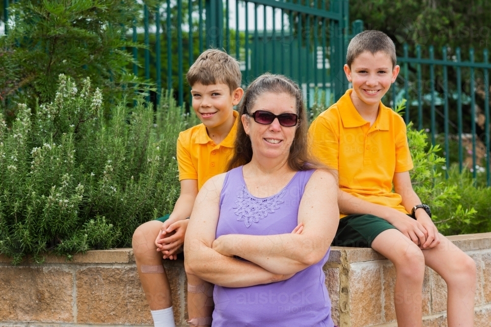 Image of Portrait of a middle aged school mum and her boys - Austockphoto