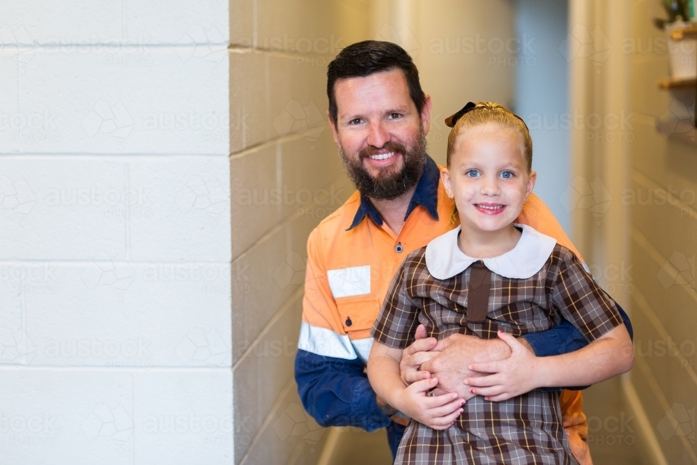 Image of Portrait of a tradie dad with his daughter ready to go back to ...