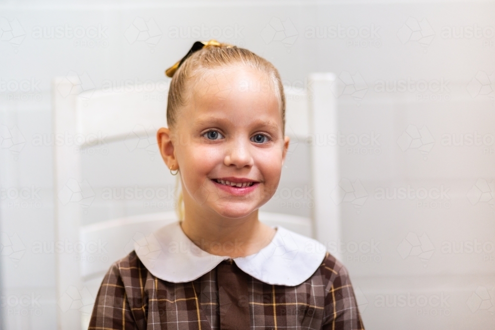 Image of Portrait of a young school child inside ready to go to primary ...