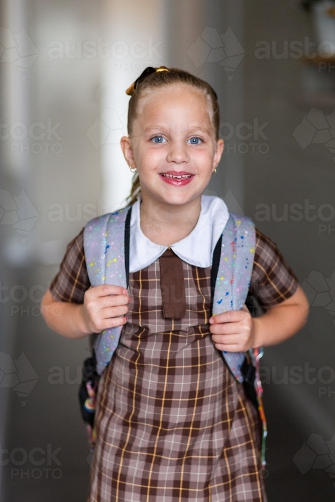 Image of Portrait of a young school child inside ready to go to primary ...