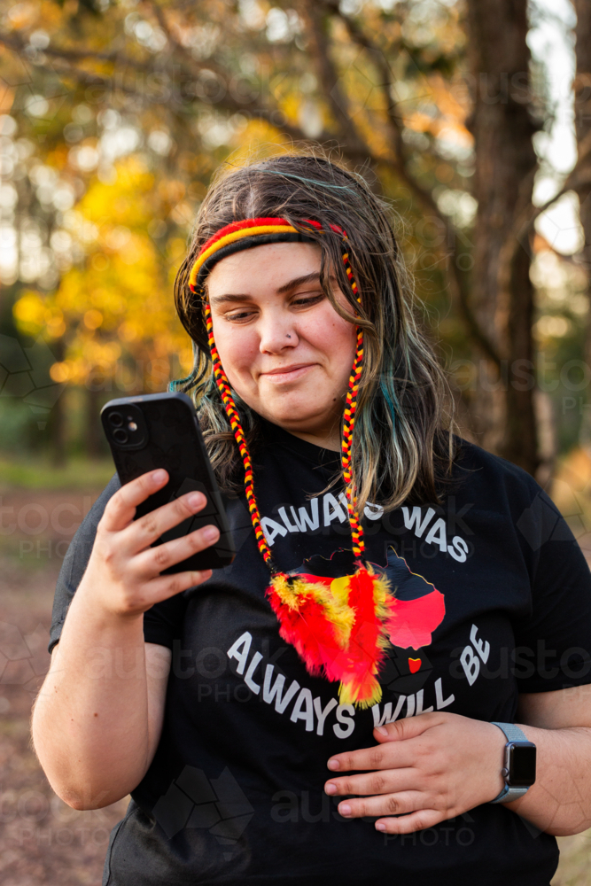 Image of Portrait of Aboriginal Australian teenaged girl using mobile ...