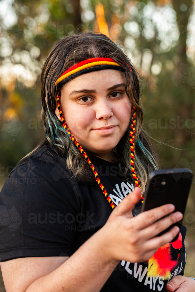 Image of Portrait of Aboriginal Australian teenaged girl using mobile ...