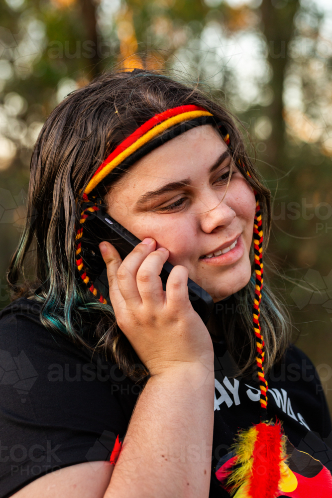 Image of Portrait of Aboriginal Australian teenaged girl using mobile ...