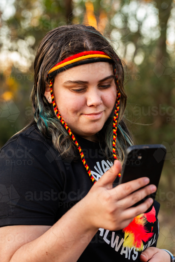 Image of Portrait of Aboriginal Australian teenaged girl using mobile ...