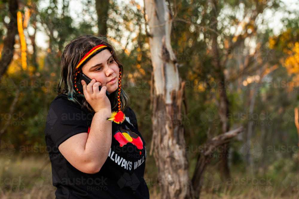Image of Portrait of Aboriginal Australian teenaged girl using mobile ...