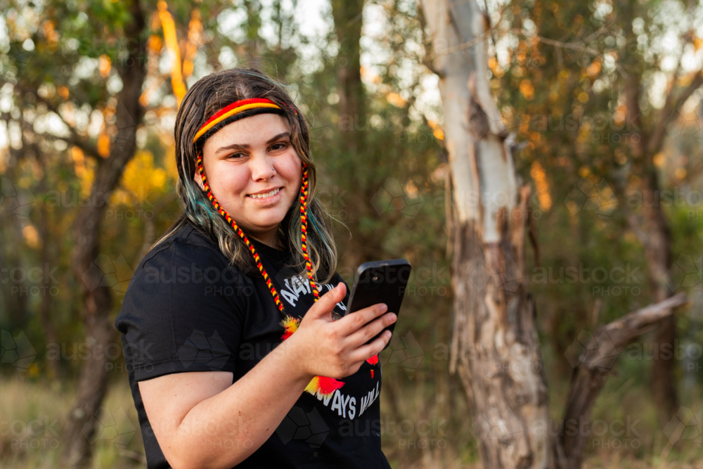 Image of Portrait of Aboriginal Australian teenaged girl using mobile ...