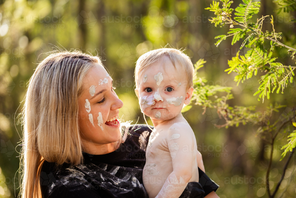 Image of Portrait of Aboriginal mum holding baby boy faces painted in ...