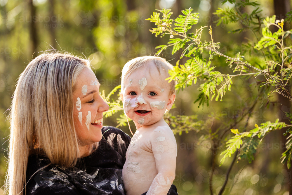 Image of Portrait of Aboriginal mum holding baby boy faces painted in ...