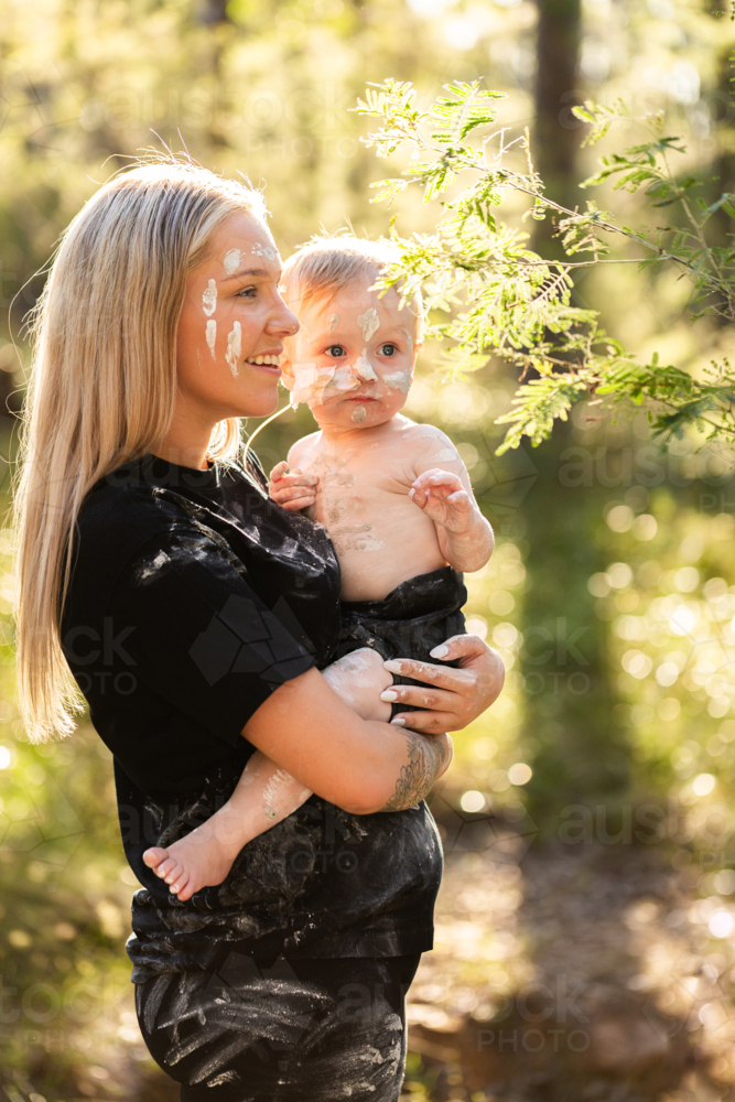 Image of Portrait of Aboriginal mum holding baby boy faces painted in ...