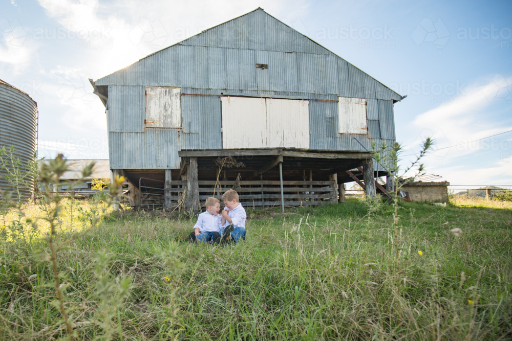 Image of Portrait of Aussie kids sitting together on grass in front of ...