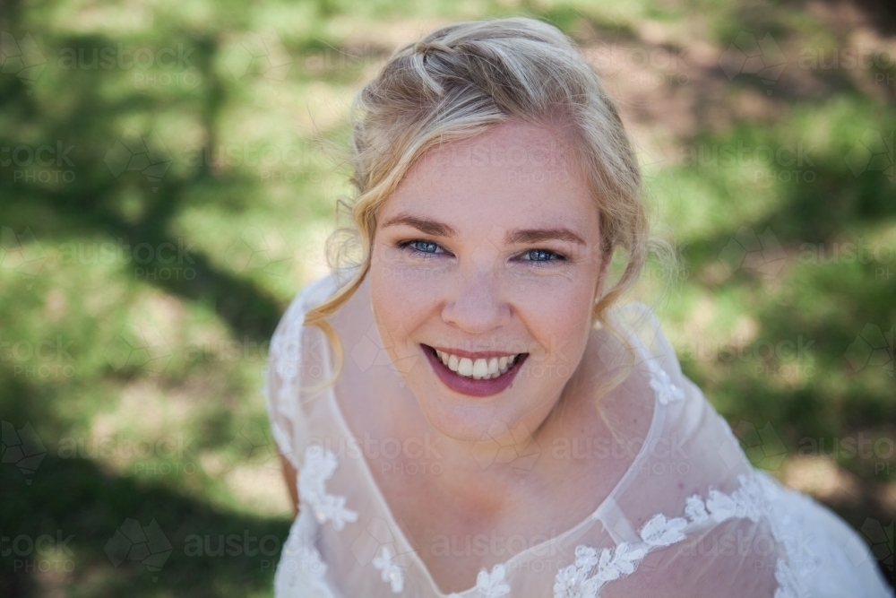 Image of Portrait of beautiful bride smiling upwards outdoors in ...