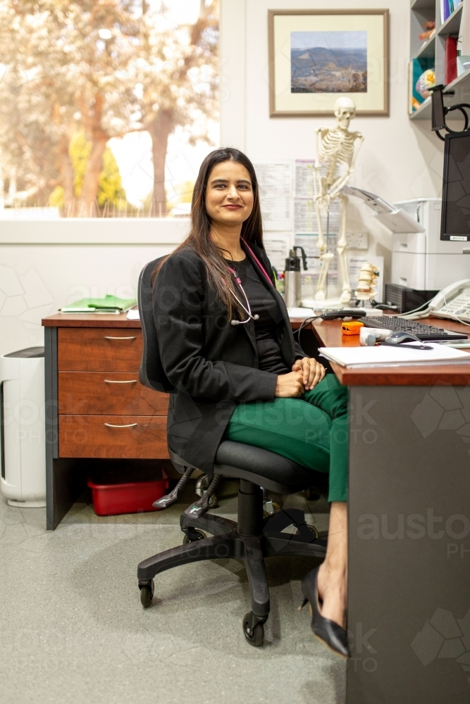 Image of Portrait of female doctor sitting in her medical office ...