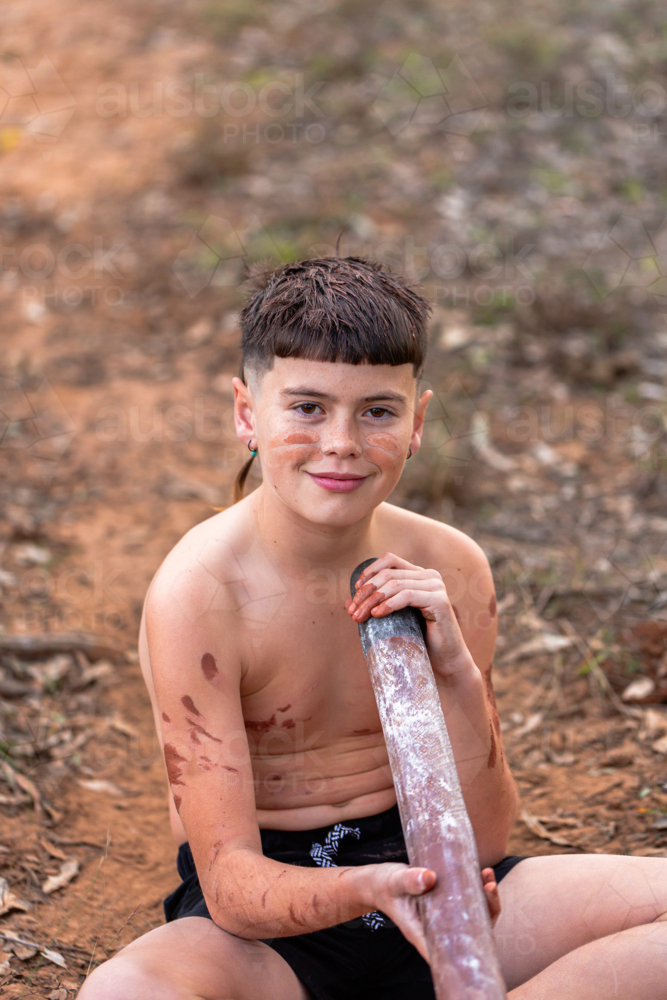 Image of Portrait of First Nations Australian kid holding didgeridoo ...