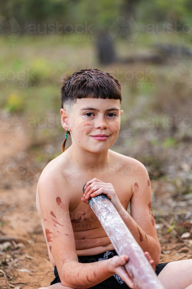 Image of Portrait of First Nations Australian kid holding didgeridoo ...