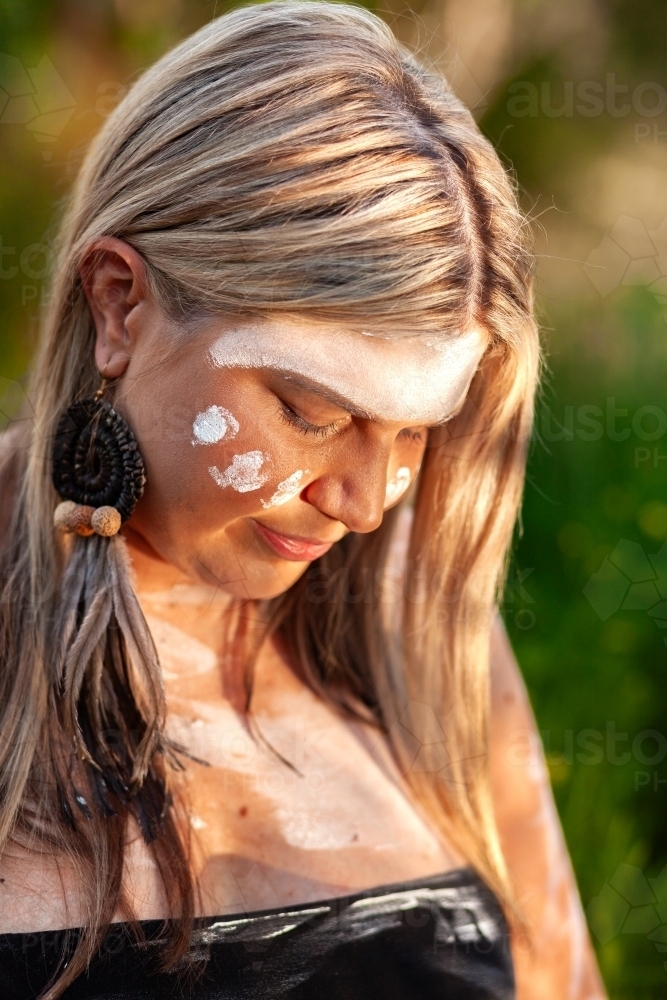 Image of portrait of first nations Australian woman wearing ochre paint ...