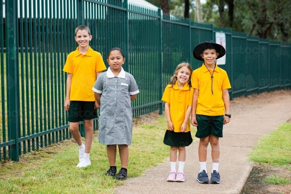 Image of Portrait of four happy school friends at an Australian public ...