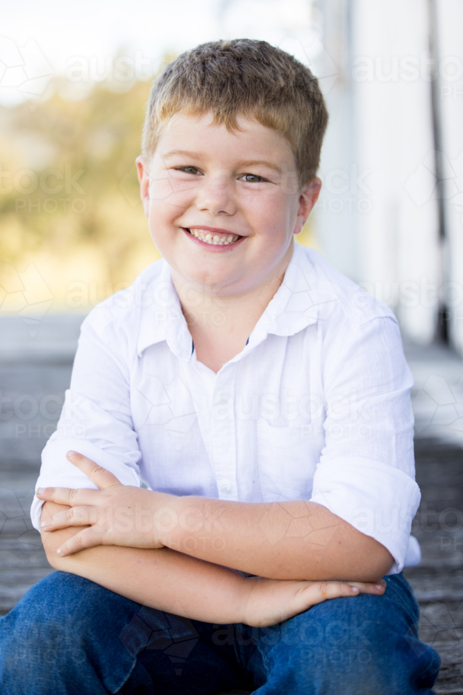 Image of Portrait of happy little boy smiling on farm - Austockphoto