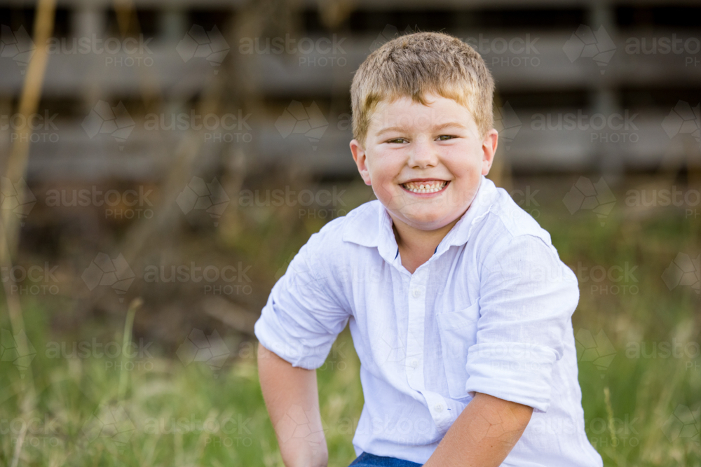 Image of Portrait of happy little boy smiling on farm - Austockphoto