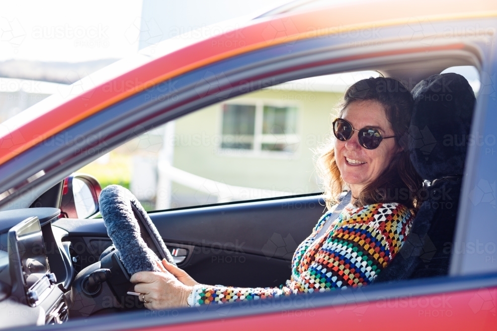 Image of Portrait of happy middle aged woman driving electric vehicle ...