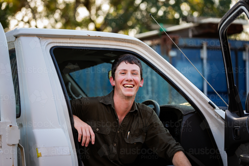 Image of Portrait of happy smiling teenaged young man sitting in his ...