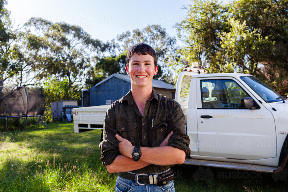 Image of Portrait of happy smiling teenaged young person standing by ...