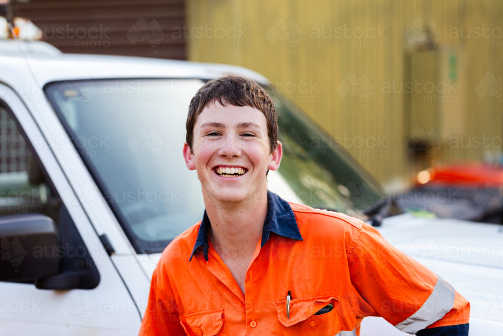 Image of Portrait of happy smiling young male trade apprentice in high ...
