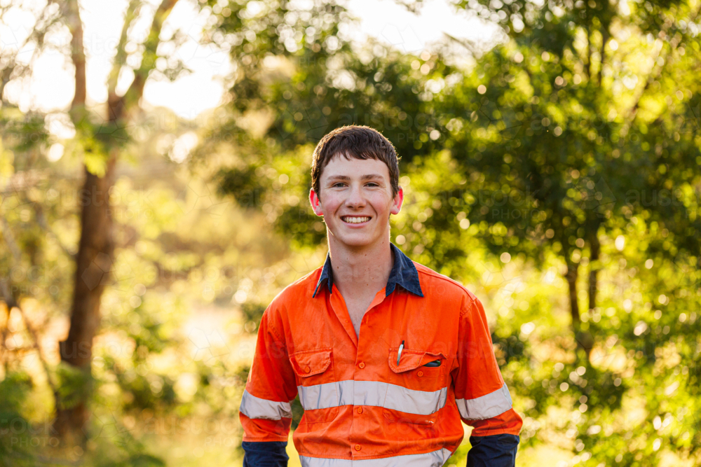 Image of Portrait of happy young tradesman apprentice in high vis ...