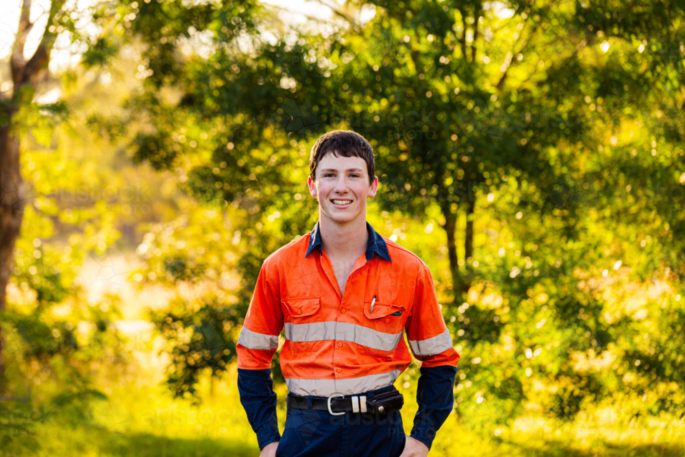 Image of Portrait of happy young tradesman apprentice in high vis ...