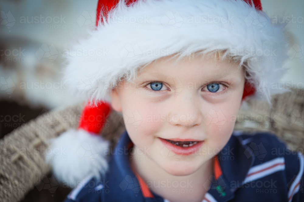 Image of Portrait of little boy wearing Santa hat at Christmas time ...