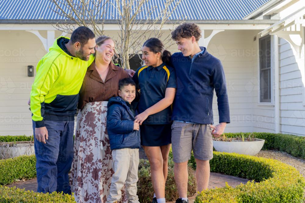 Image of Portrait of mixed ethnicity family standing on brick pathway ...