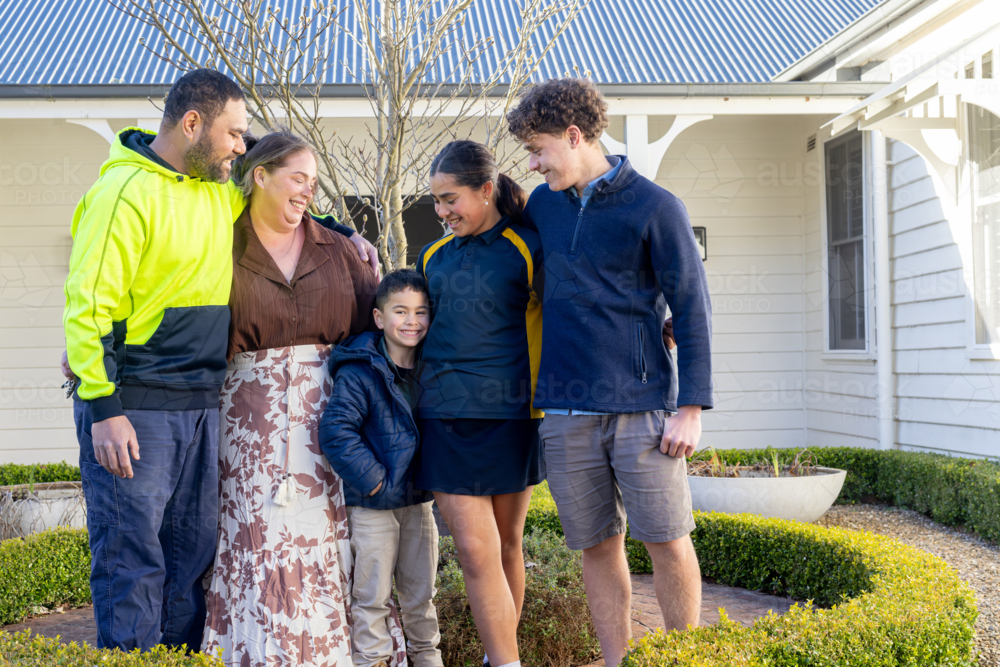 Image of Portrait of mixed ethnicity family standing on brick pathway ...