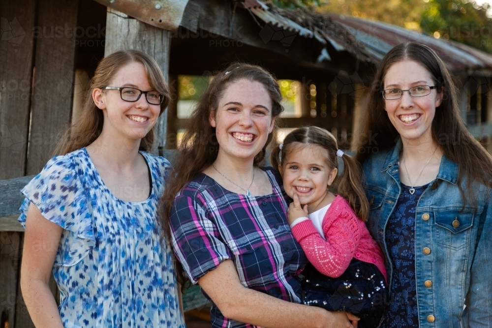 Image of Portrait of sisters smiling at camera - Austockphoto