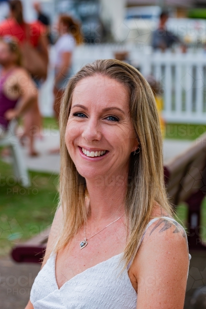 Image of Portrait of smiling woman in her forties at event - Austockphoto