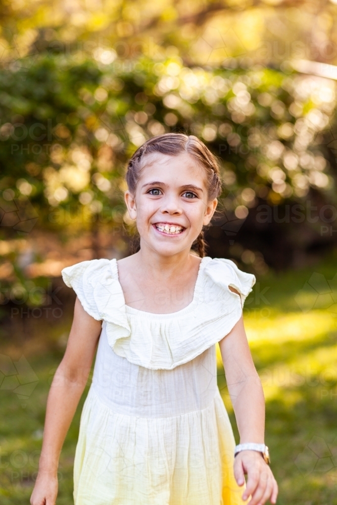 Image of Portrait of smiling young aussie kid in yellow dress and ...