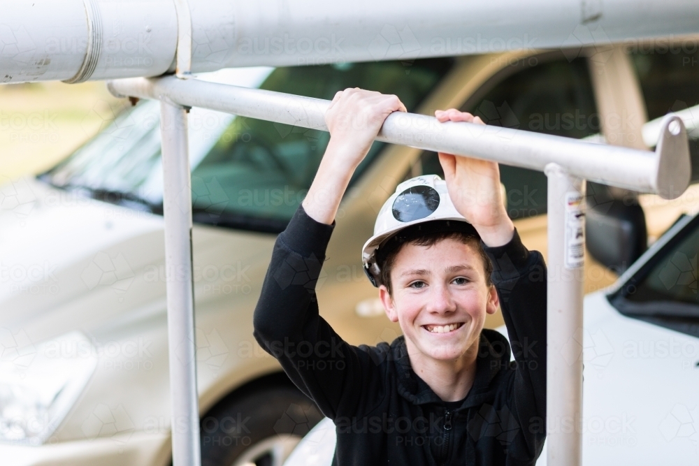 Image of Portrait of teenage boy son of a tradie smiling - Austockphoto