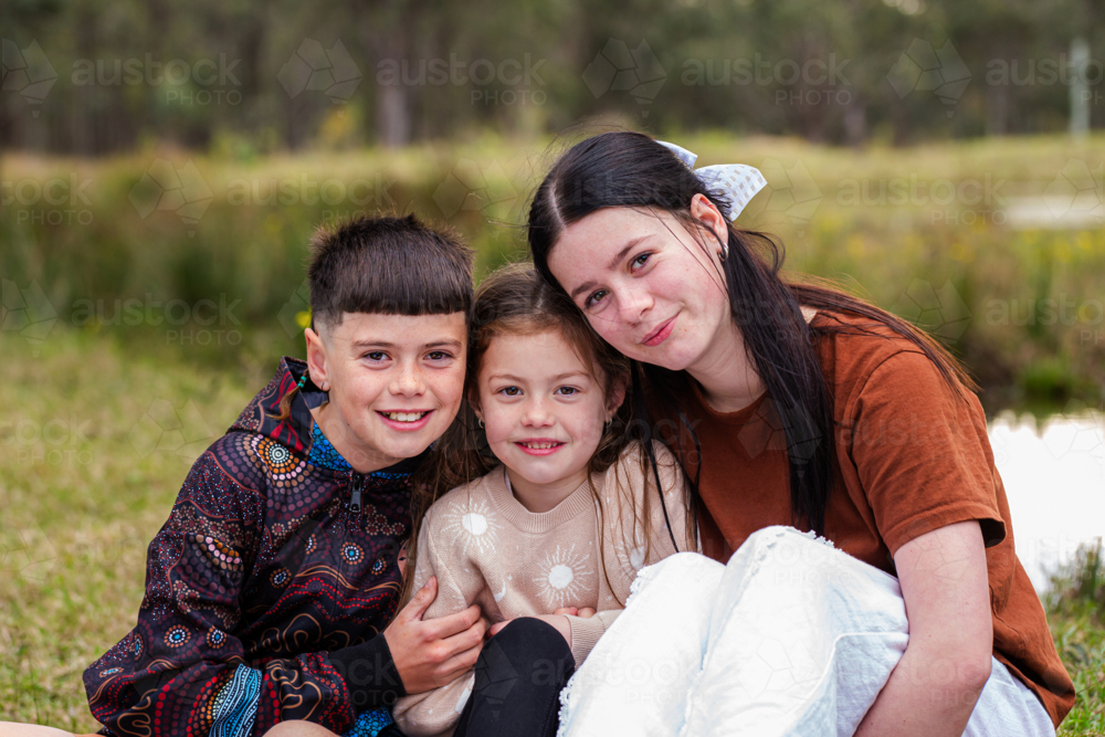 Image of Portrait of three first nations Australian siblings sitting ...