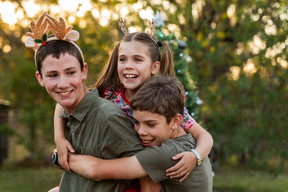Image of Portrait of three happy siblings at Christmas time in ...
